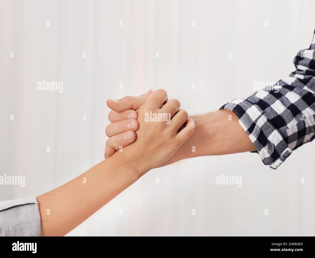 People holding hands together on light background. Concept of support ...