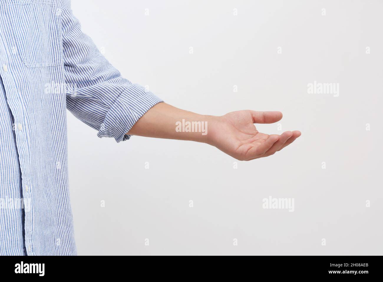 Man giving helping hand on light background Stock Photo - Alamy