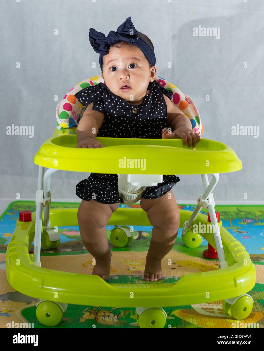 Cute Malaysian baby in a baby walker Stock Photo - Alamy