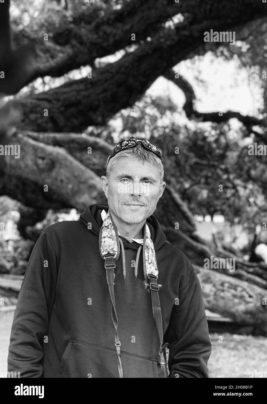 Grayscale shot of a man posing in the park or forest Stock Photo - Alamy