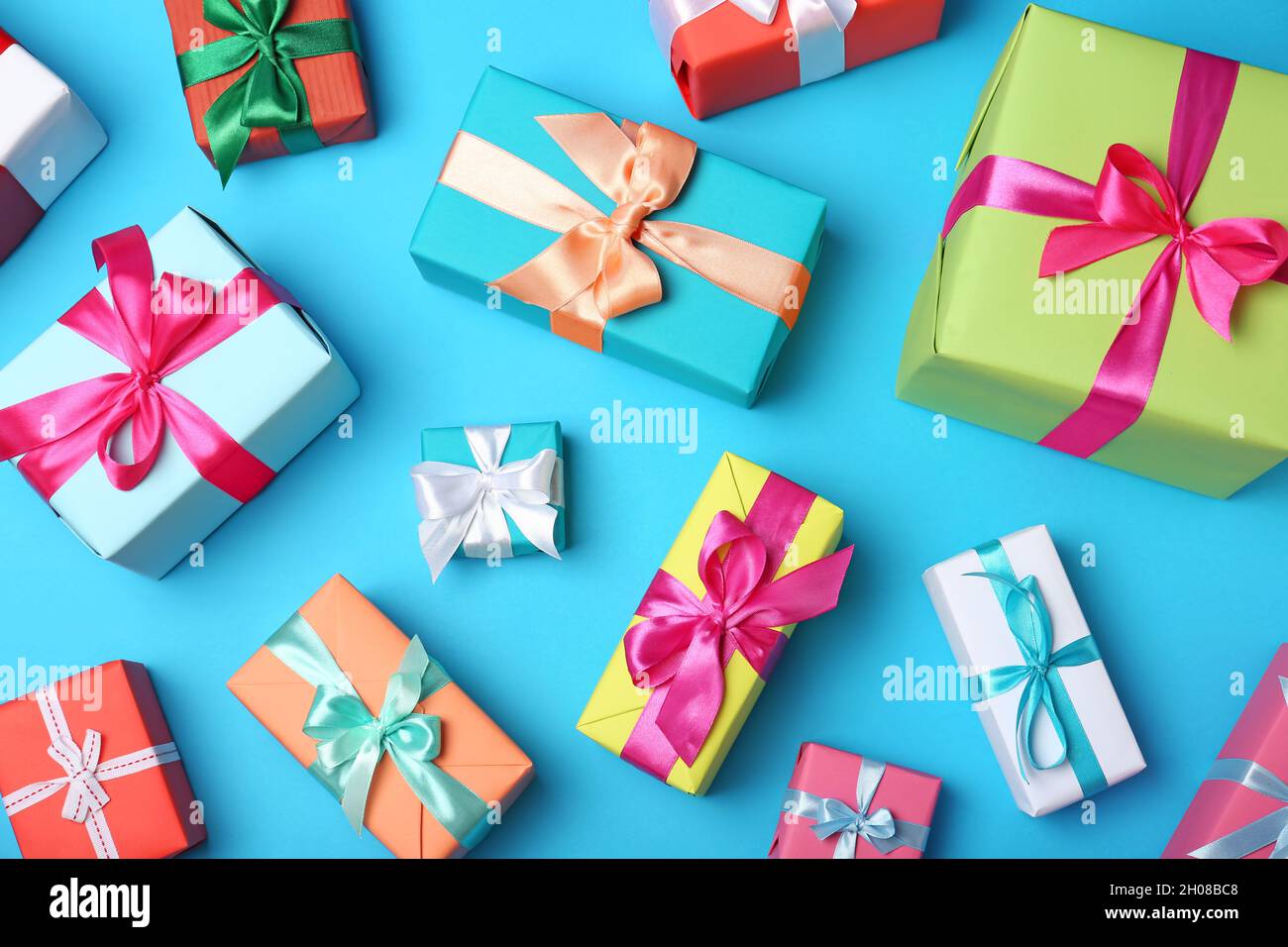 Flat lay composition with beautiful gift boxes on color background ...