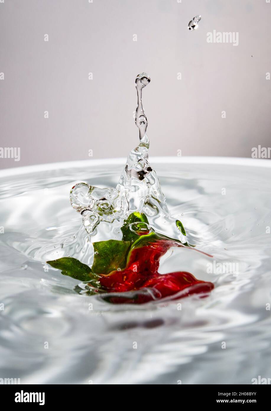 Water jet created by a strawberry falling into water Stock Photo - Alamy
