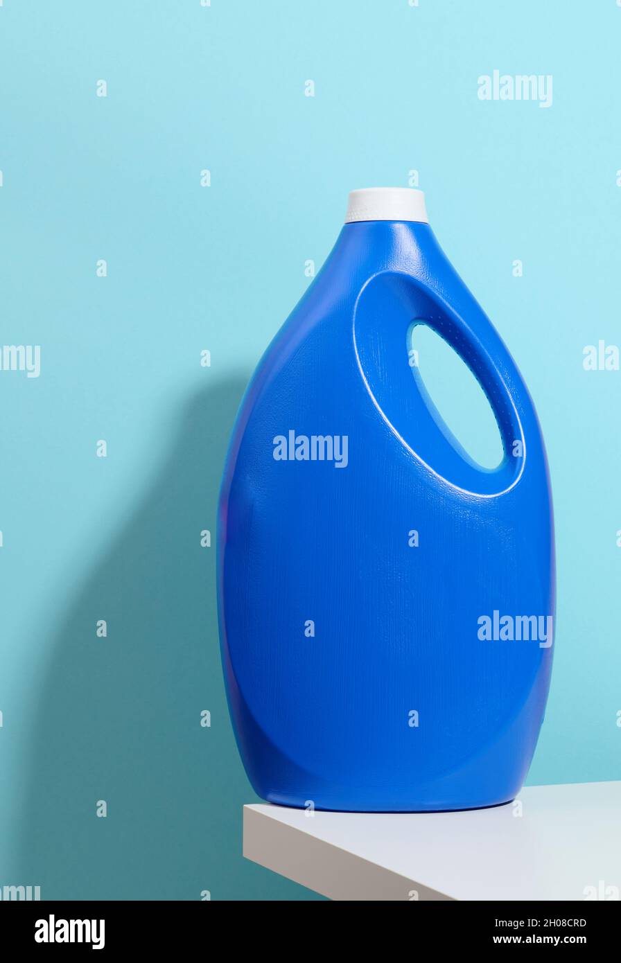 blue plastic bottle for liquid washing powder on a white table Stock ...