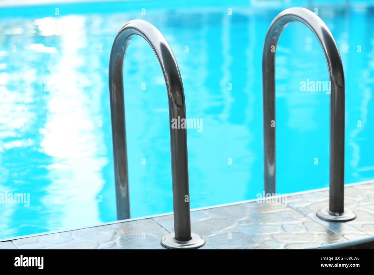 Modern swimming pool with stairs at resort Stock Photo - Alamy