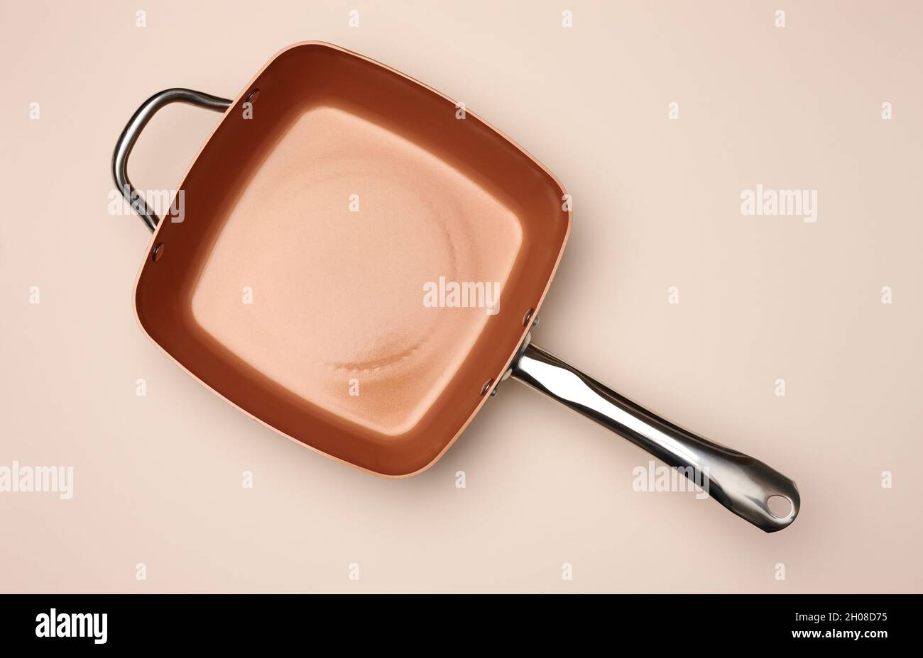 new copper deep frying pan on a beige background, top view Stock Photo ...