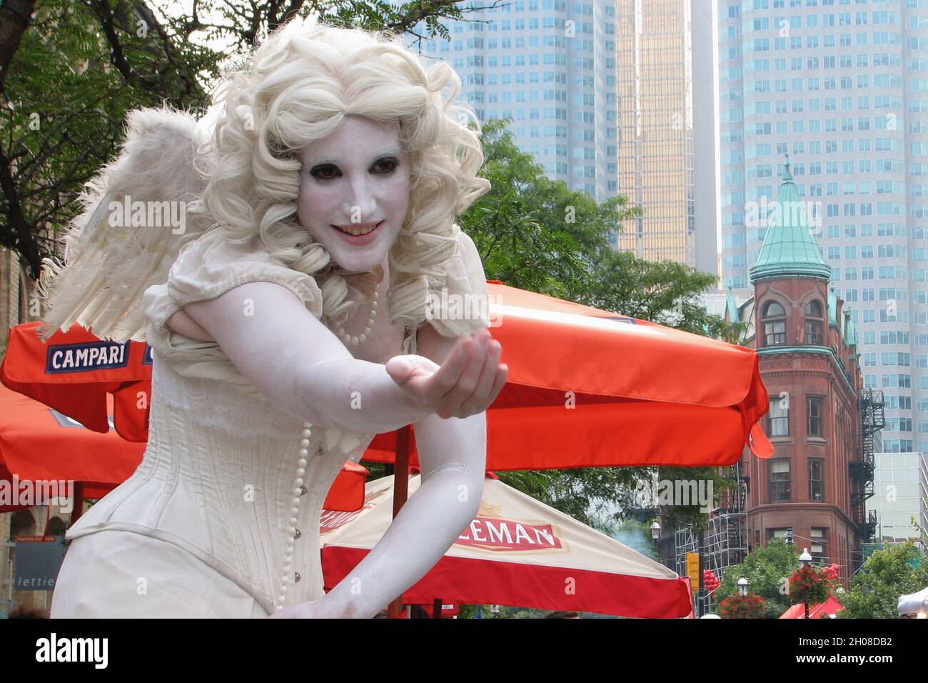 Street performer wearing angel wings Stock Photo - Alamy