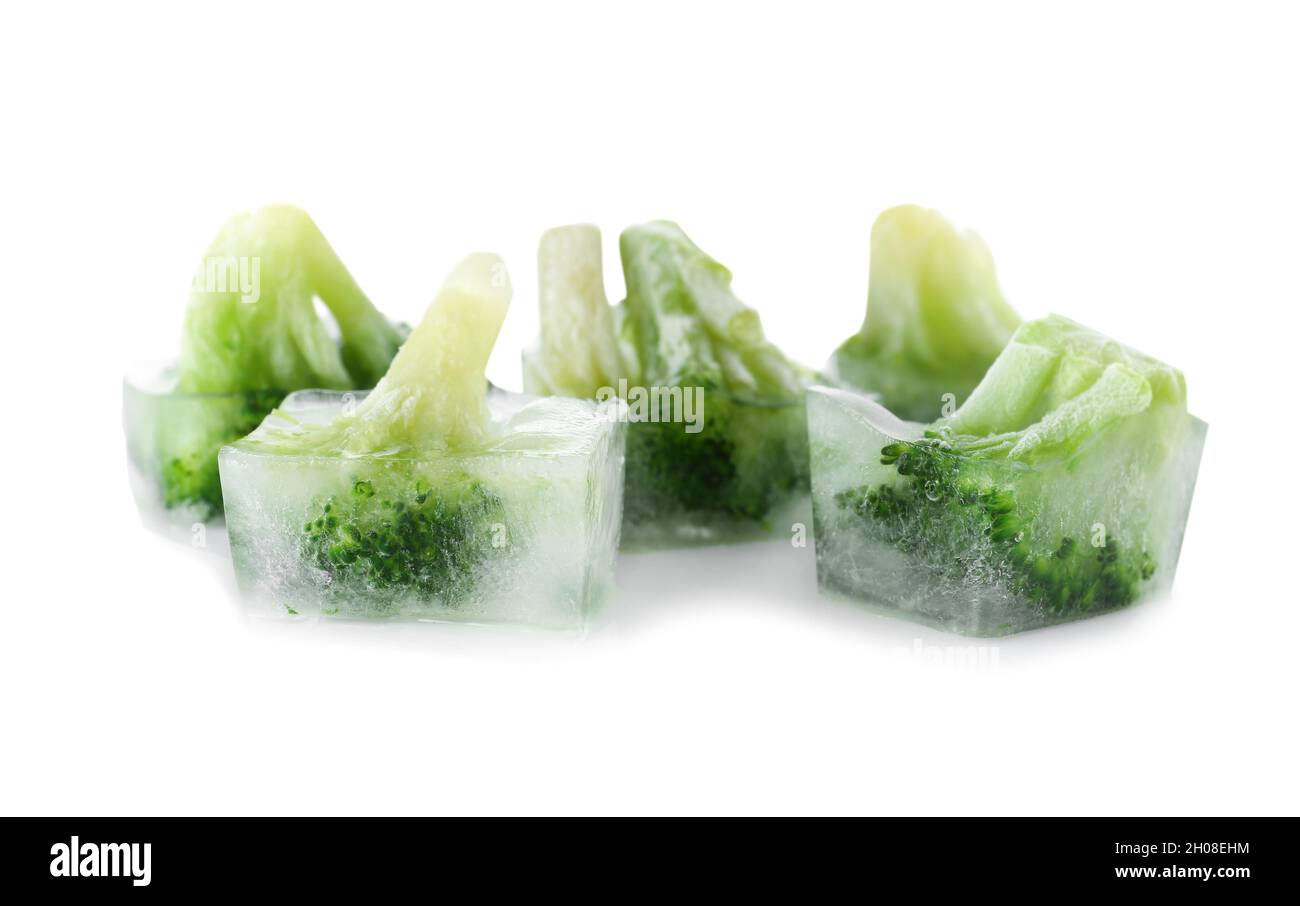 Fresh broccoli in ice cubes on white background. Frozen vegetables ...