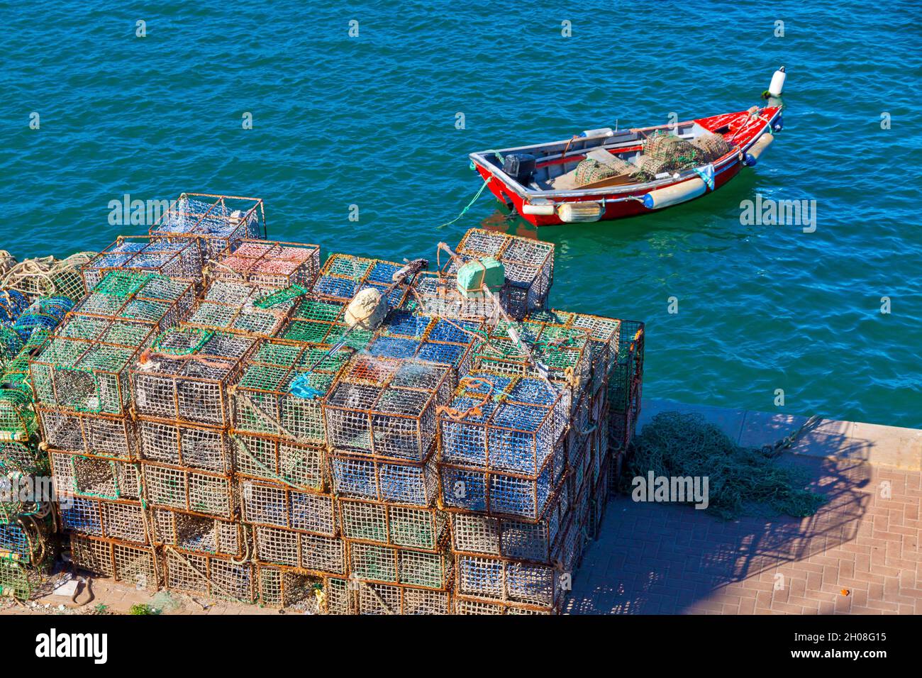 Fishing boat and a string of fishing nets and cages in the Bay of ...