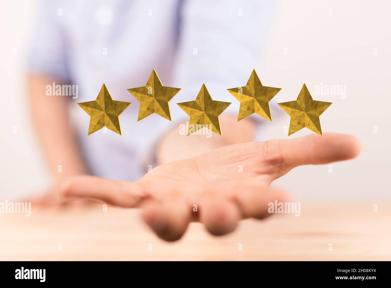 Human hand showing 5 stars rating quality Stock Photo - Alamy