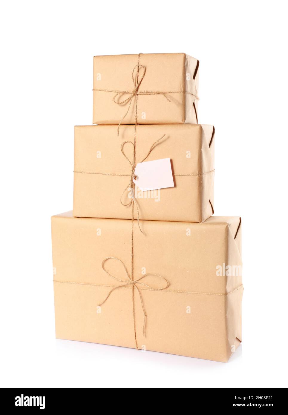 Stacked parcels wrapped in kraft paper on white background Stock Photo ...