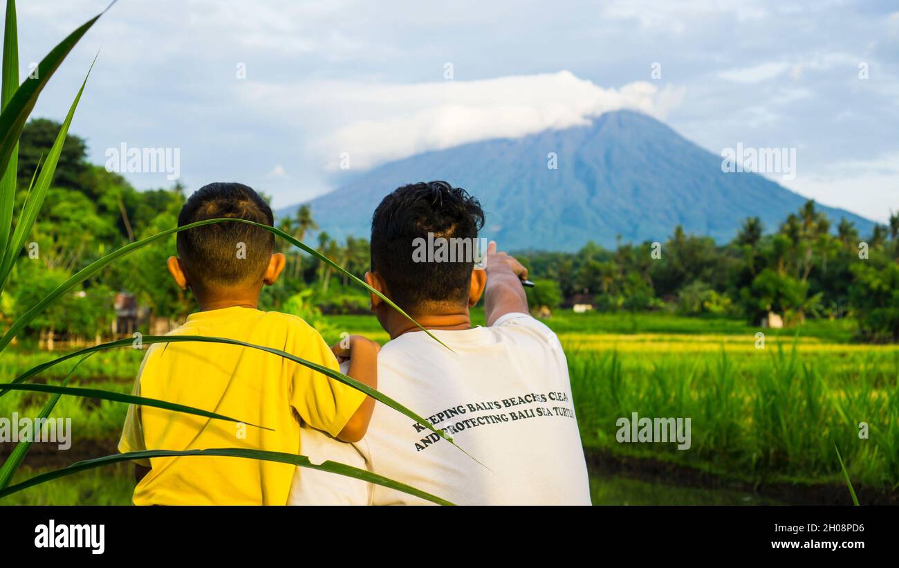 Adult male showing a boy a beautiful scenery of a mountain Stock Photo ...