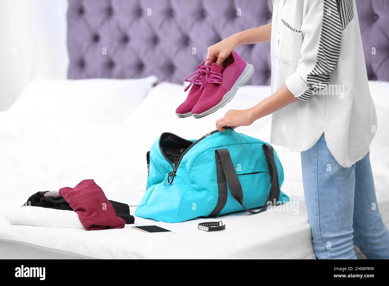 Woman packing essentials in bag hi-res stock photography and images - Alamy