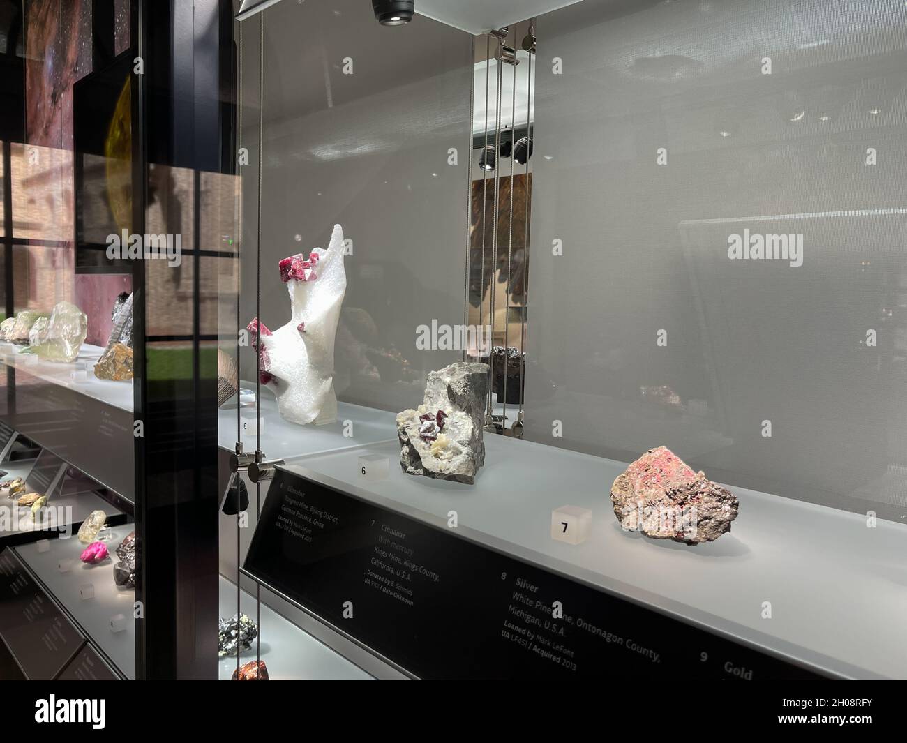 Gems, minerals and previous stones on display in a glass case at museum ...