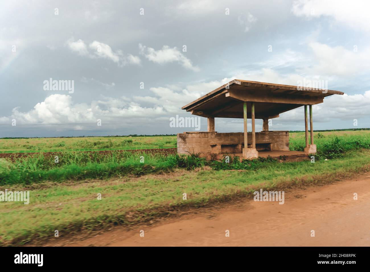 Tranquil landscape of an old rural bus stop in the field Stock Photo ...