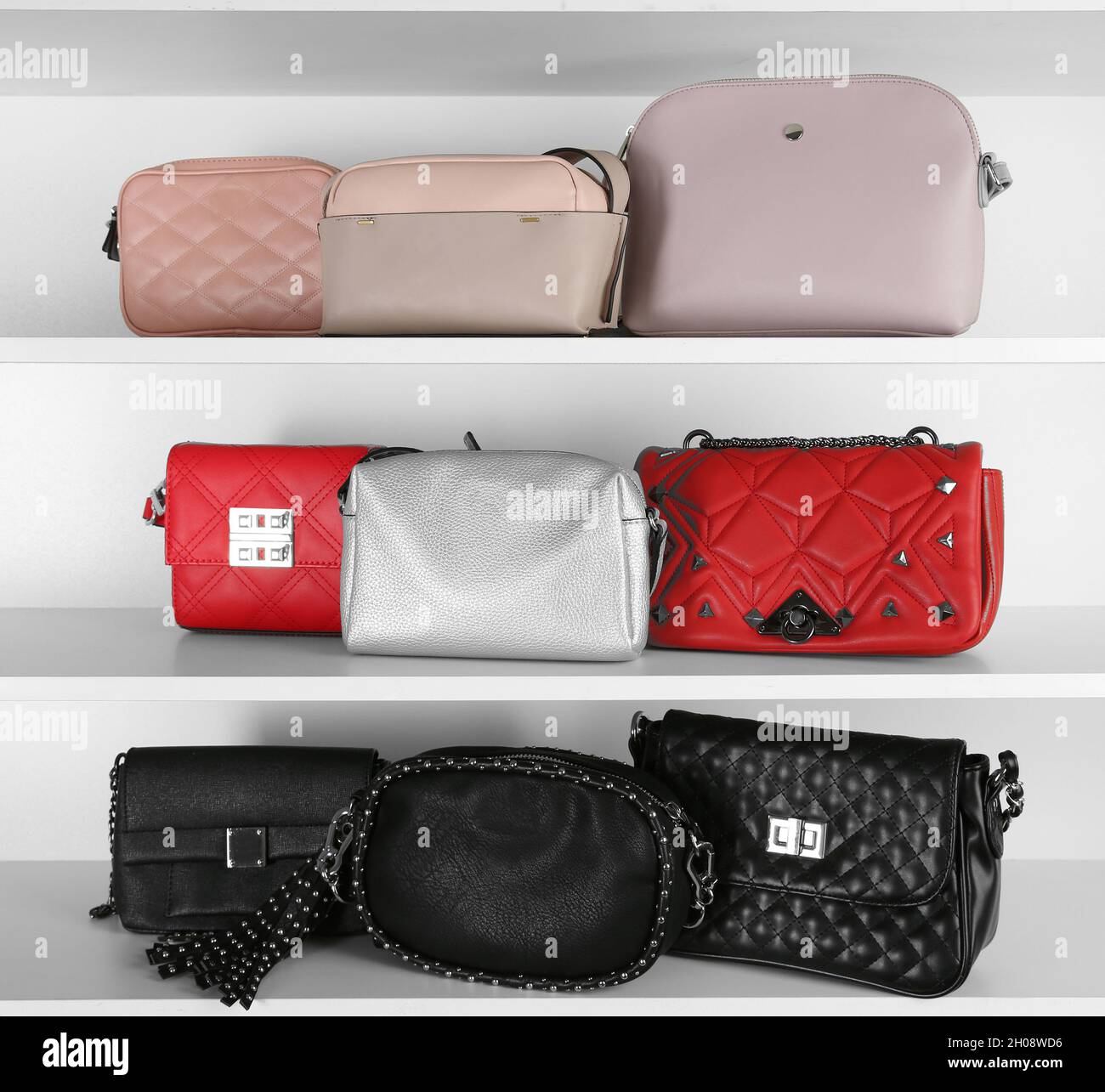 White shelving unit with stylish purses, closeup. Element of dressing ...