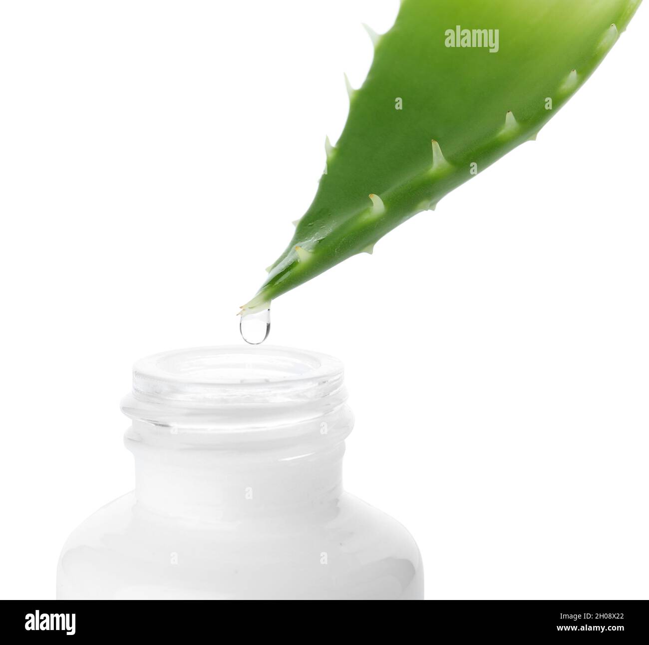 Aloe juice dripping from leaf into bottle on white background Stock ...
