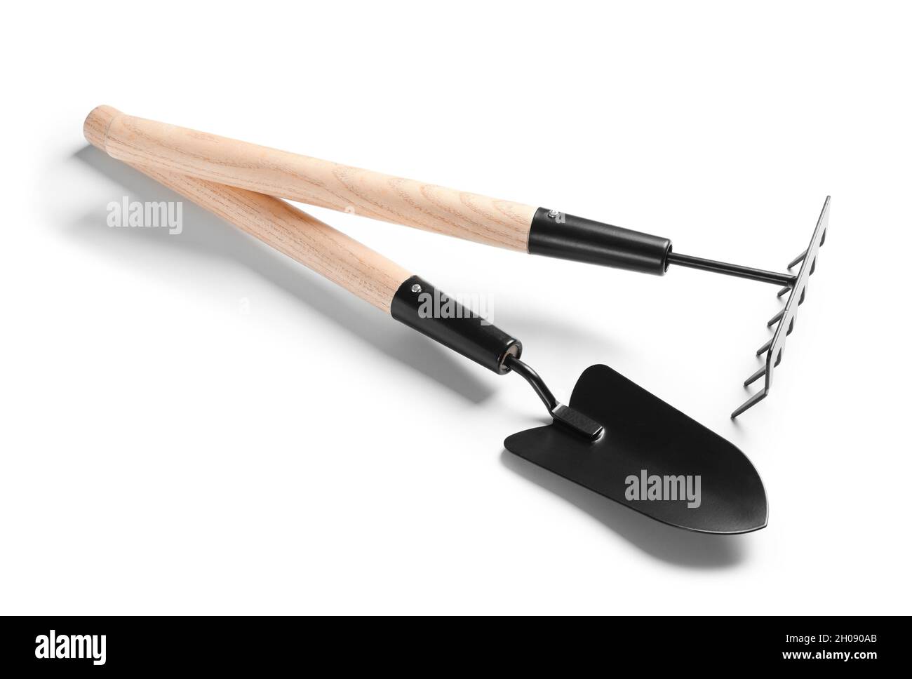 New rake and trowel on white background. Professional gardening tools ...