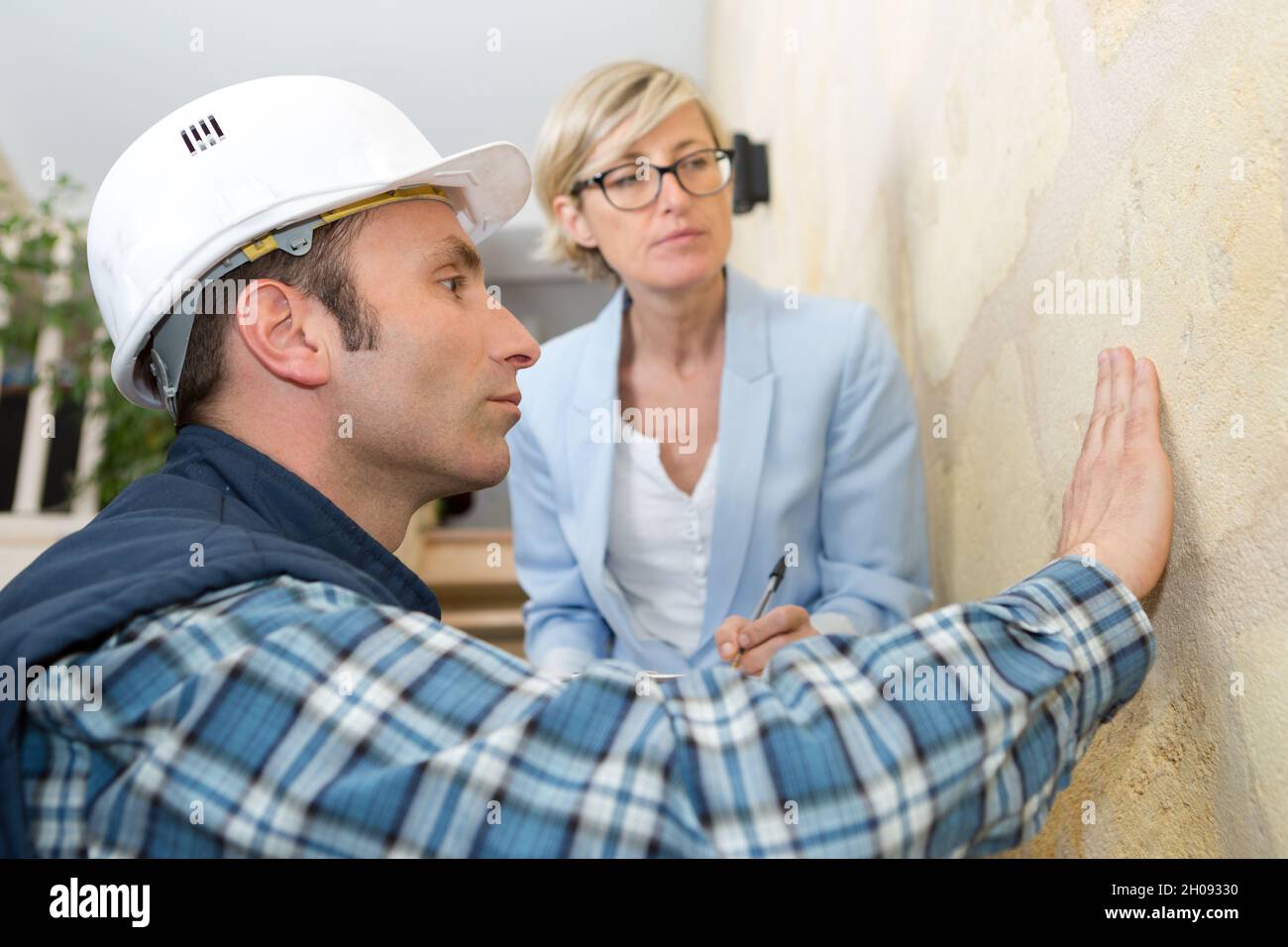 builder and architect working together and inspecting finishing Stock ...