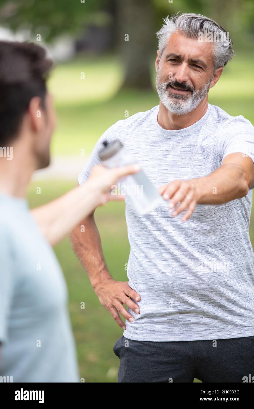 two man runners standing talking after running Stock Photo - Alamy