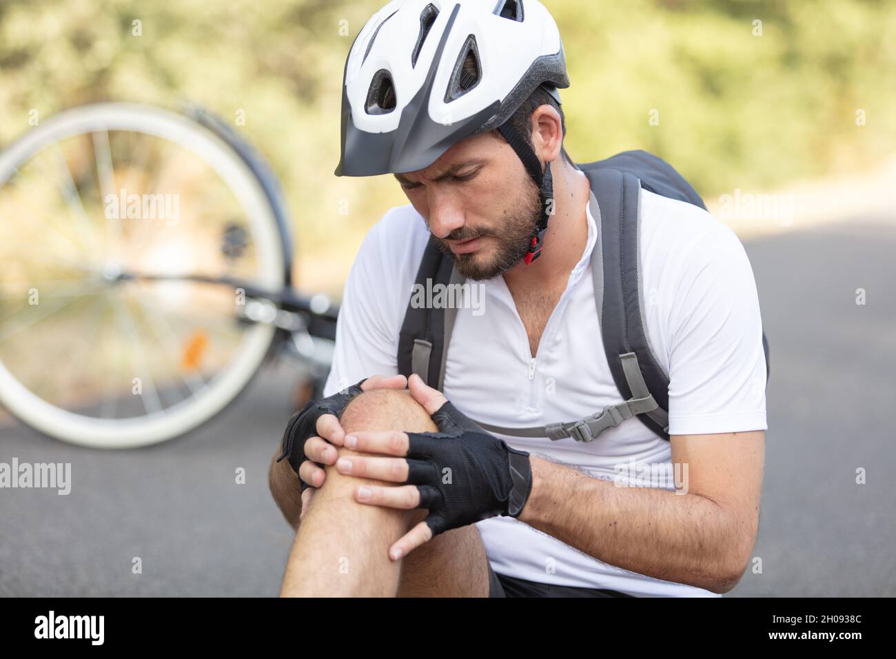 man cyclist fell fell off road bike while cycling Stock Photo - Alamy