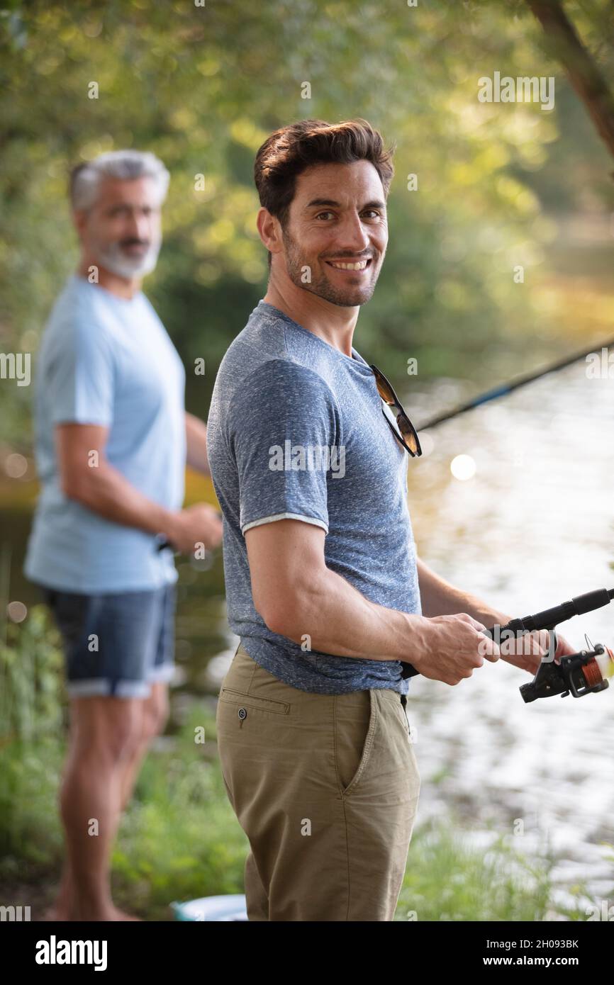 two male friends are fishing Stock Photo - Alamy
