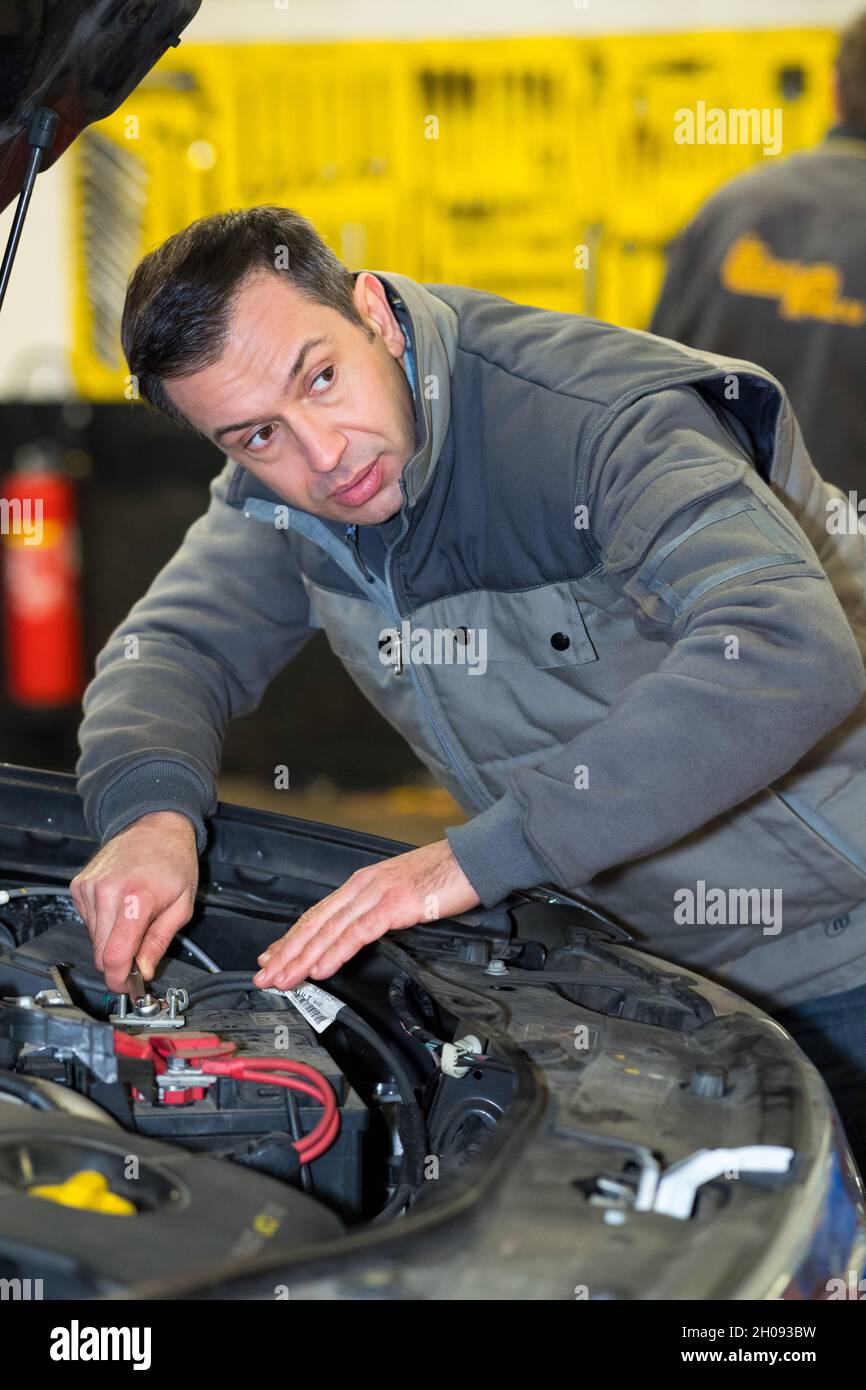 car mechanic man at the garage fixing the engine Stock Photo - Alamy
