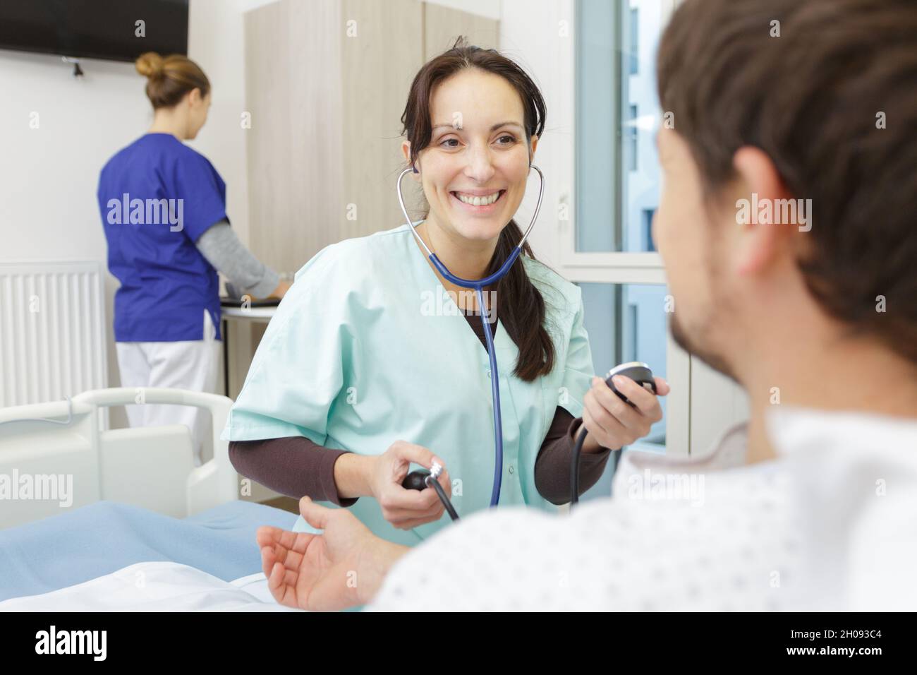 happy doctor checking patients blood pressure Stock Photo - Alamy