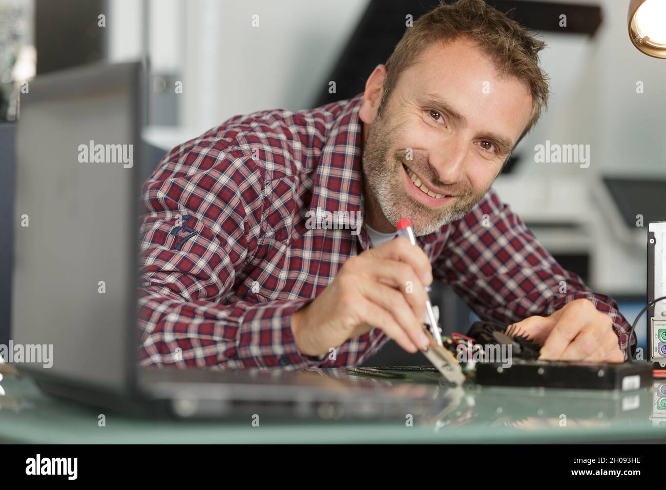 a happy man fixing pc Stock Photo - Alamy