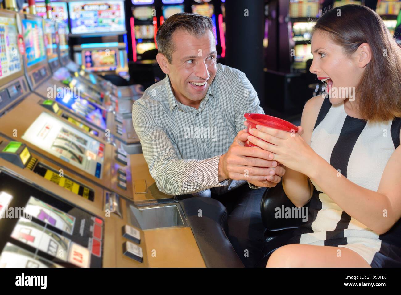 Woman playing the slot machines hi-res stock photography and images - Alamy