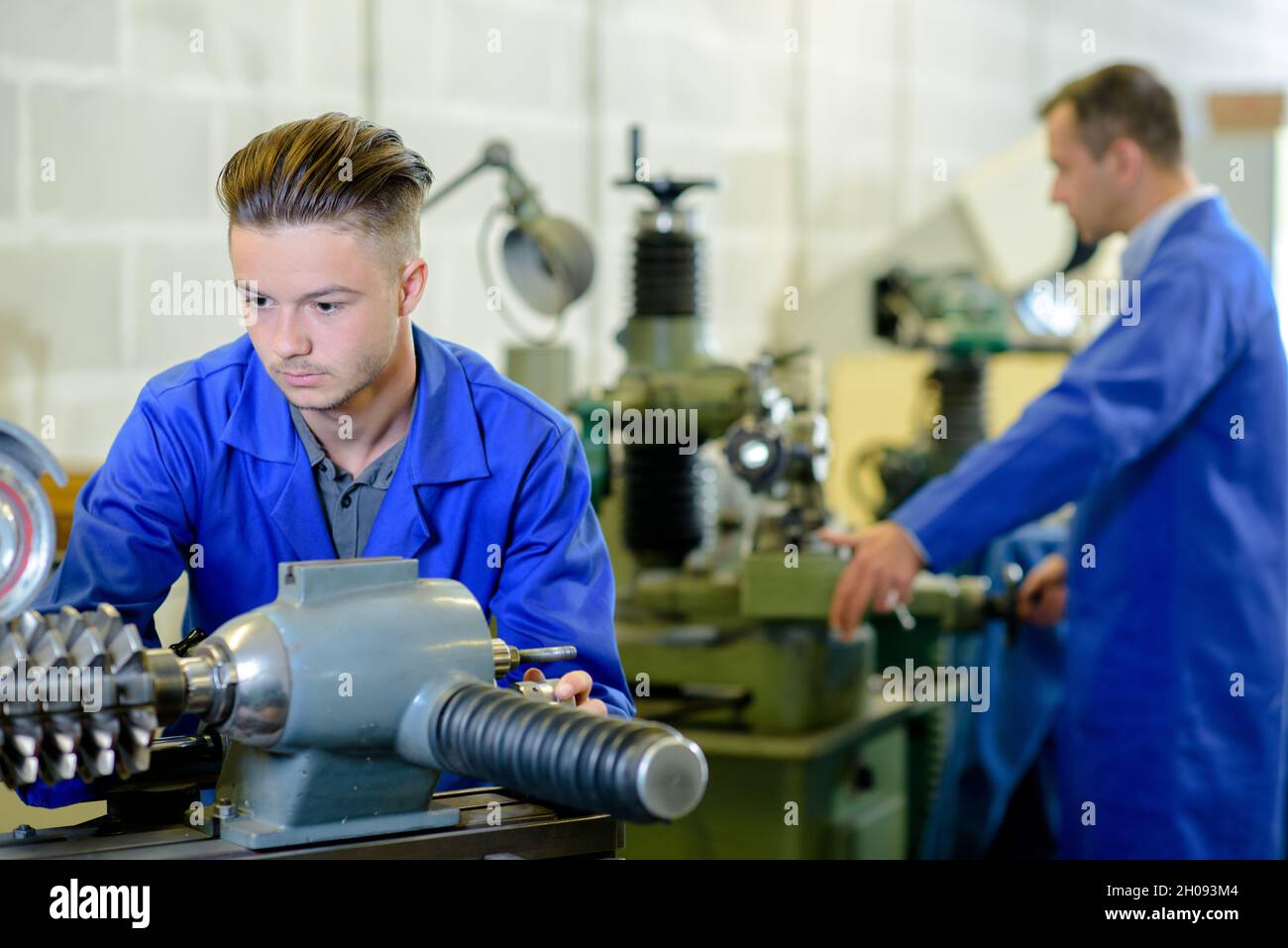 young man with a machine part Stock Photo - Alamy