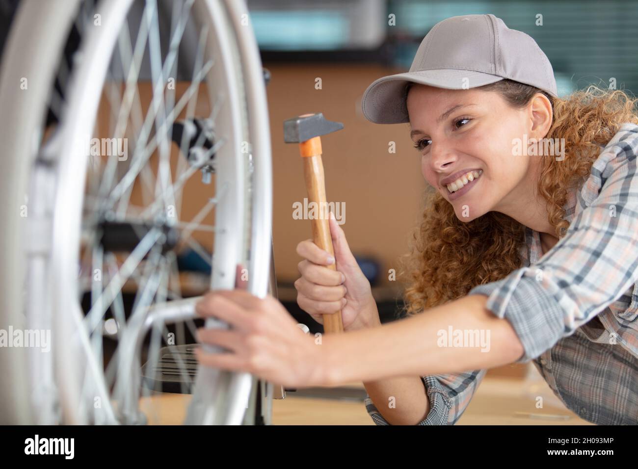female mechanic in uniform fixing a wheel Stock Photo - Alamy