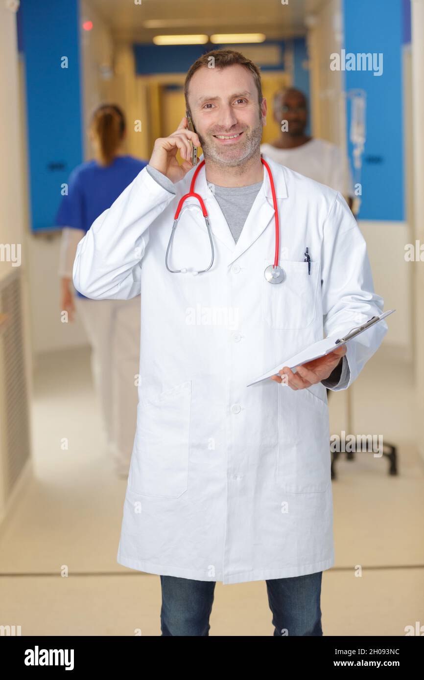surgeon calling in hospital corridor Stock Photo - Alamy