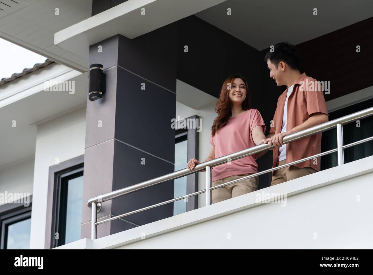 Two people talking on balcony hi-res stock photography and images - Alamy