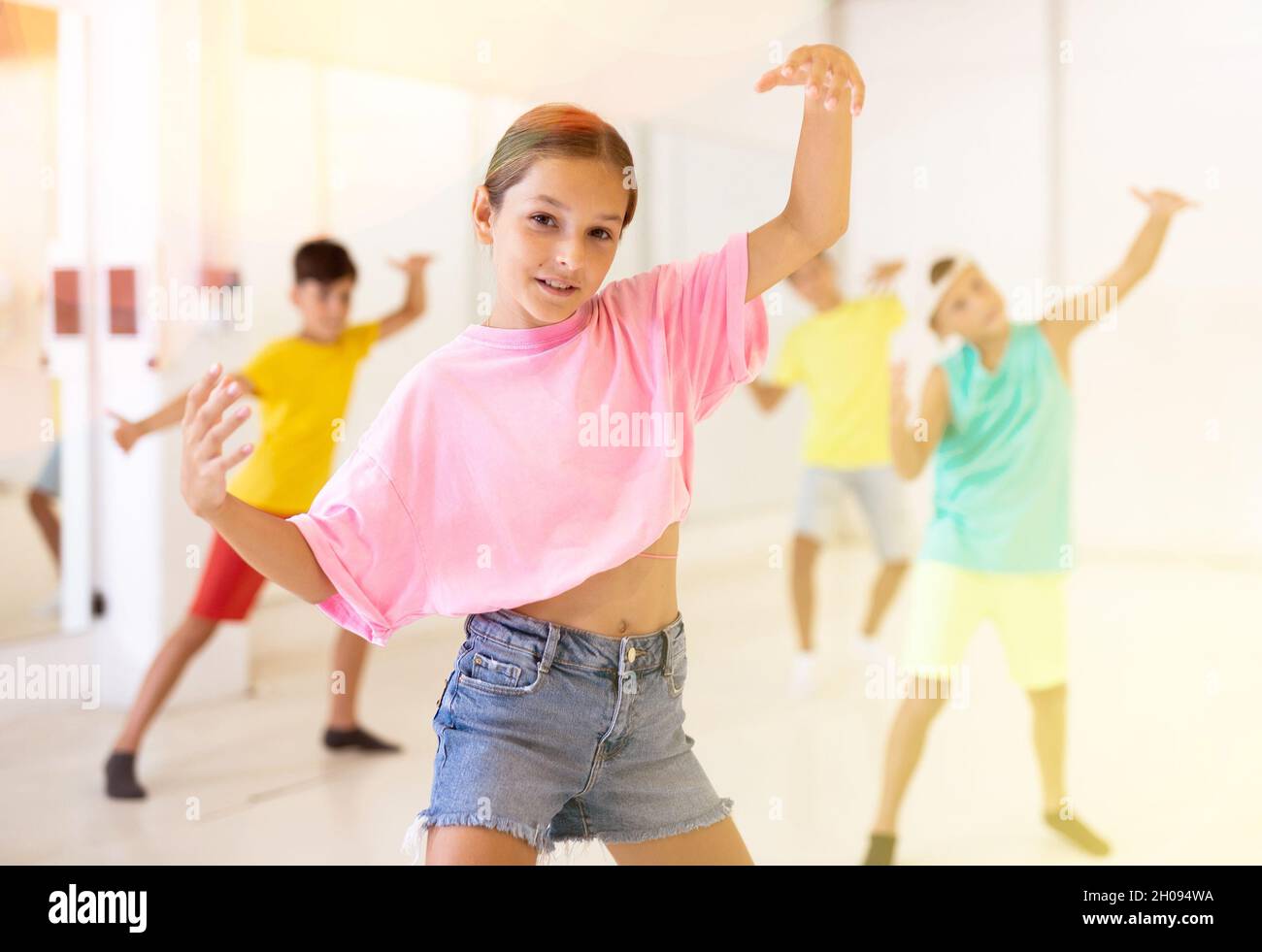 Tween girl breakdancer posing during group dance class Stock Photo - Alamy