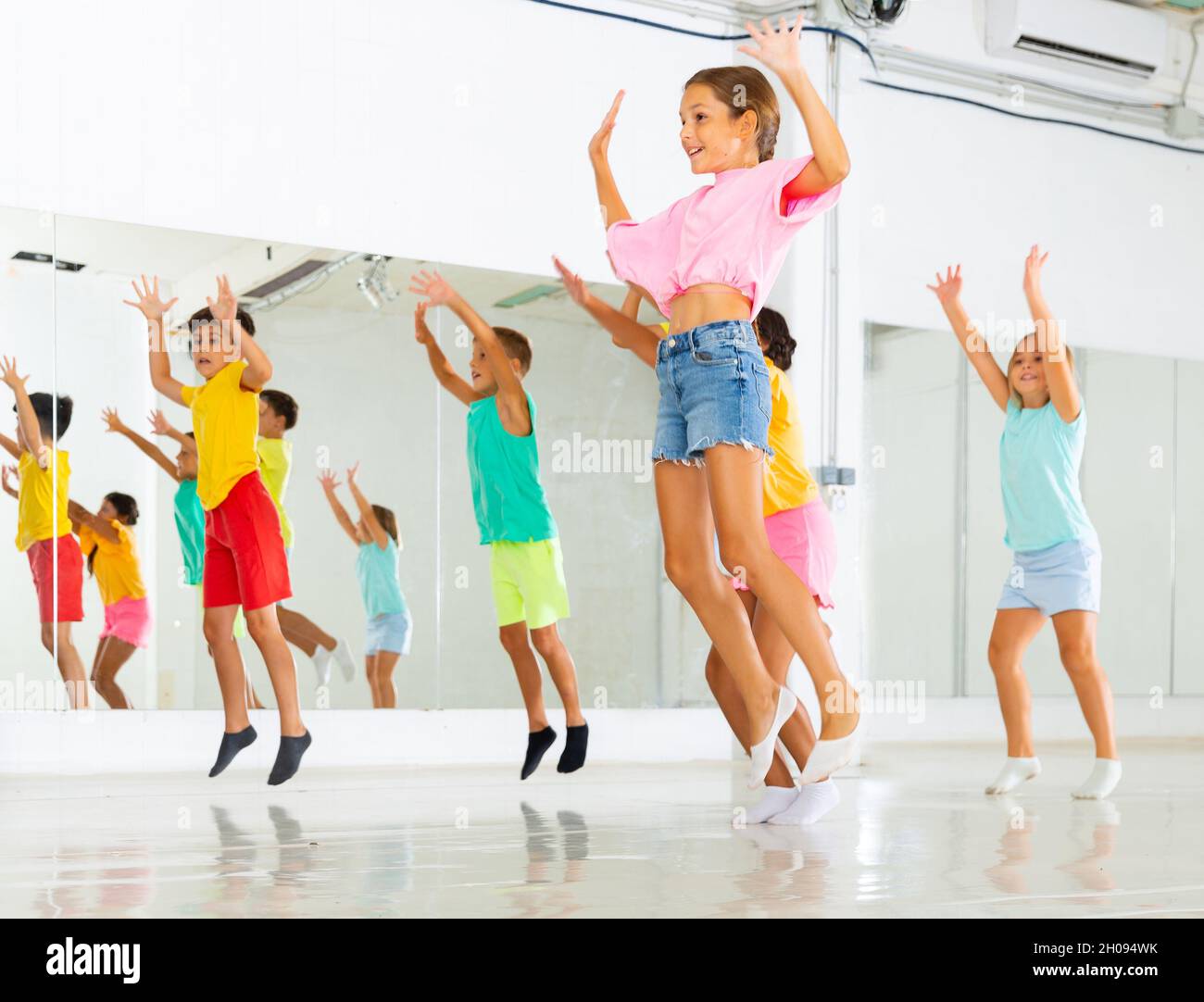 Kids jumping together in studio Stock Photo - Alamy