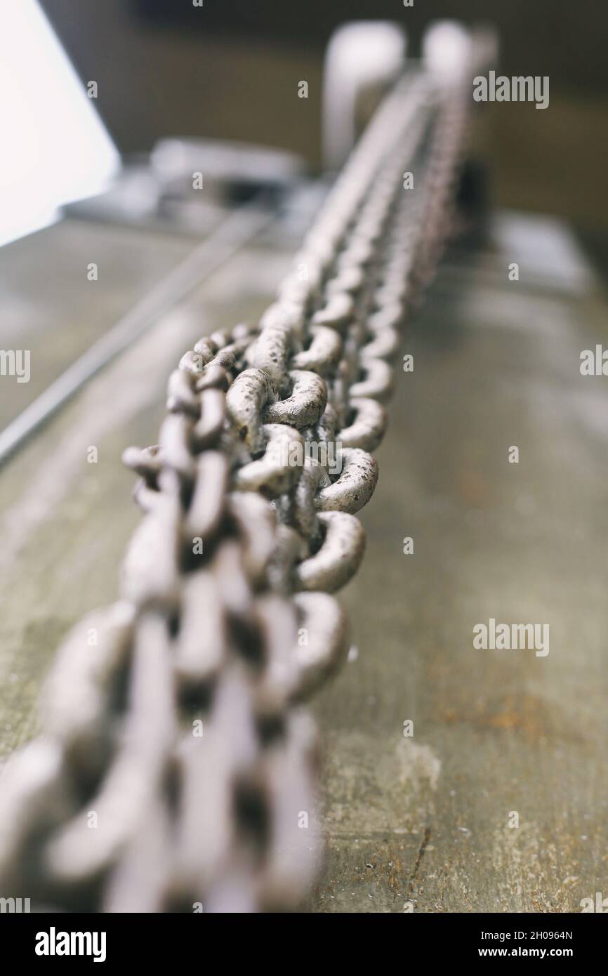 Image of tight focused steel chain hanging on the post Stock Photo - Alamy