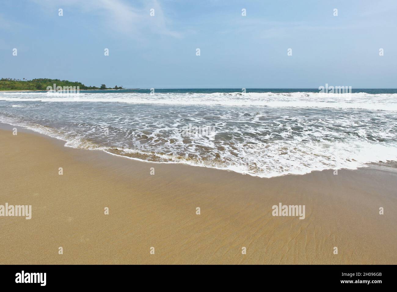Flat sandy beach with waves Stock Photo - Alamy