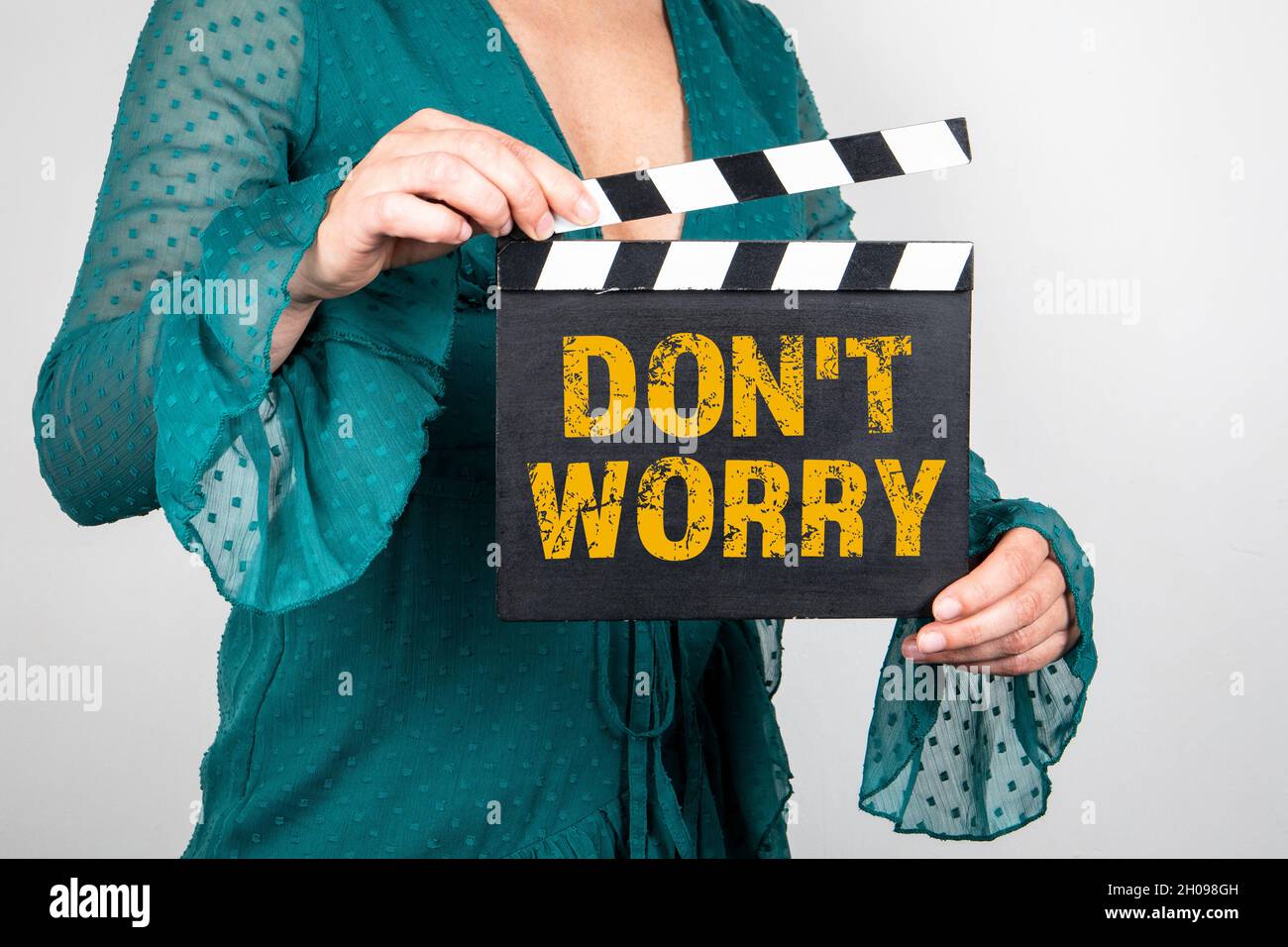 Do not worry. Female hands holding movie clapper Stock Photo - Alamy