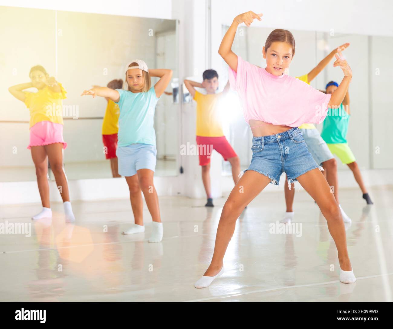 Tween girl breakdancer posing during group dance class Stock Photo - Alamy