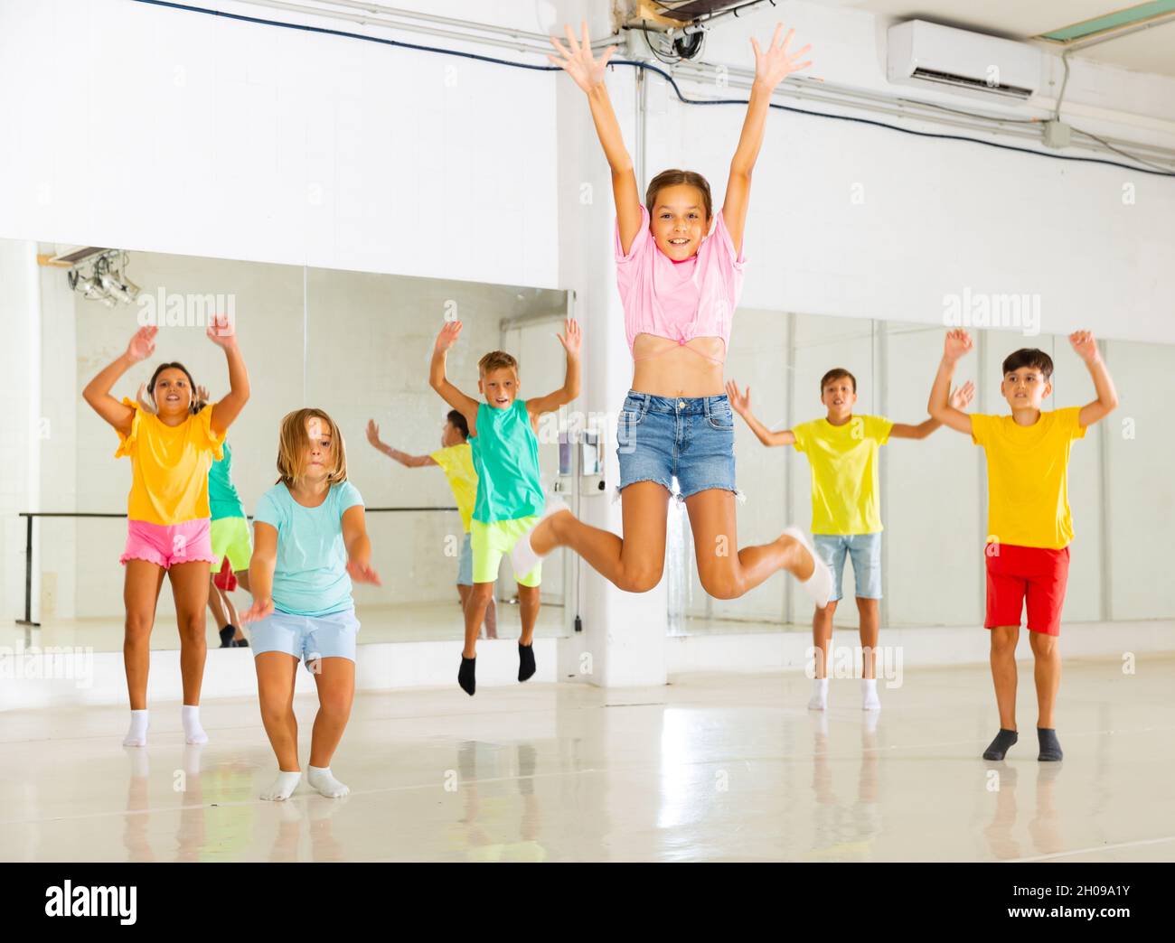 Portrait of boys and girls jumping having fun after dance class Stock ...