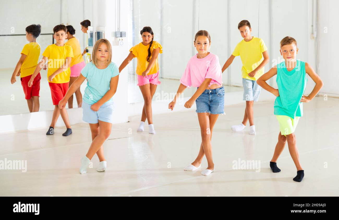 Happy tweens dancing during group class in choreographic studio Stock ...