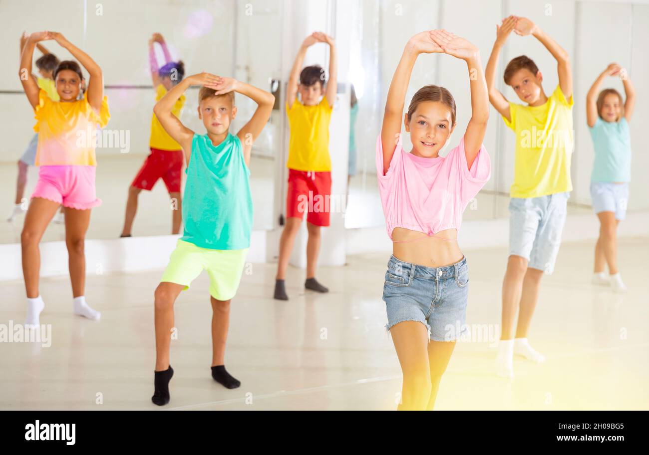 Group of children are learning dance moves in modern studio Stock Photo ...