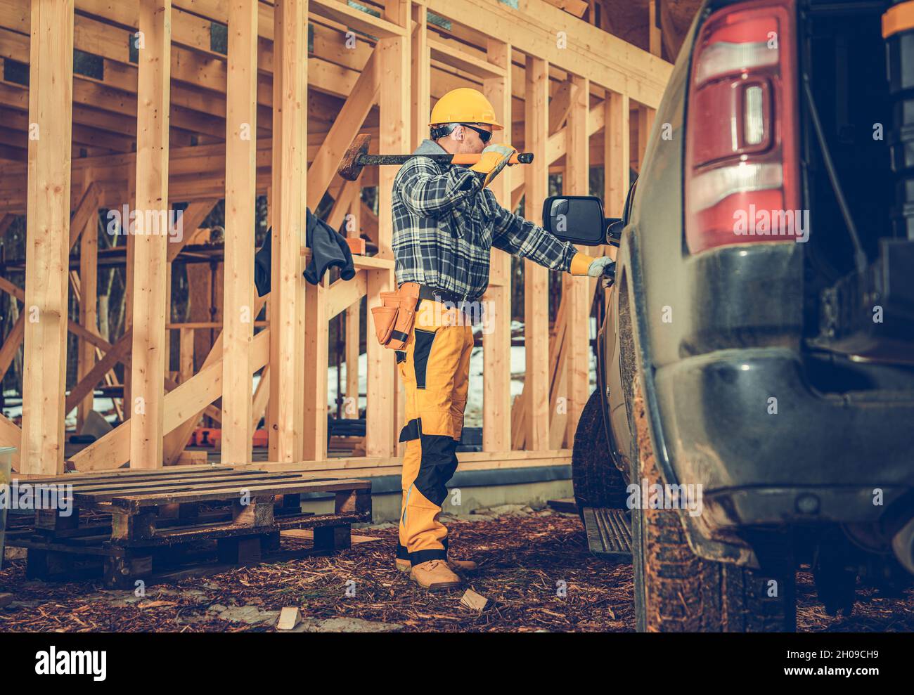 Caucasian Contractor with Large Hammer in Front of Newly Constructed ...