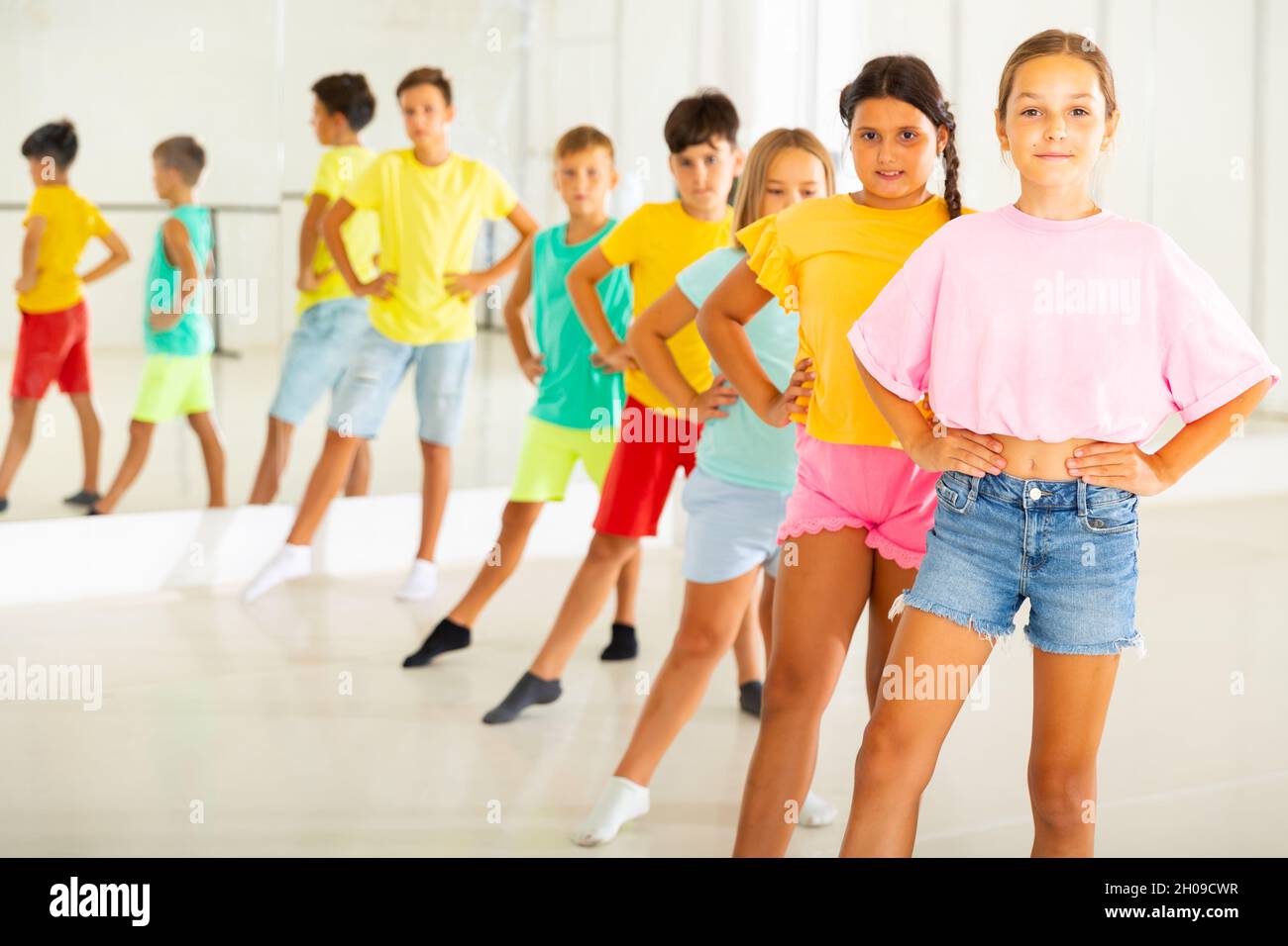 Group of children rehearsing movements of ballet in classroom Stock ...