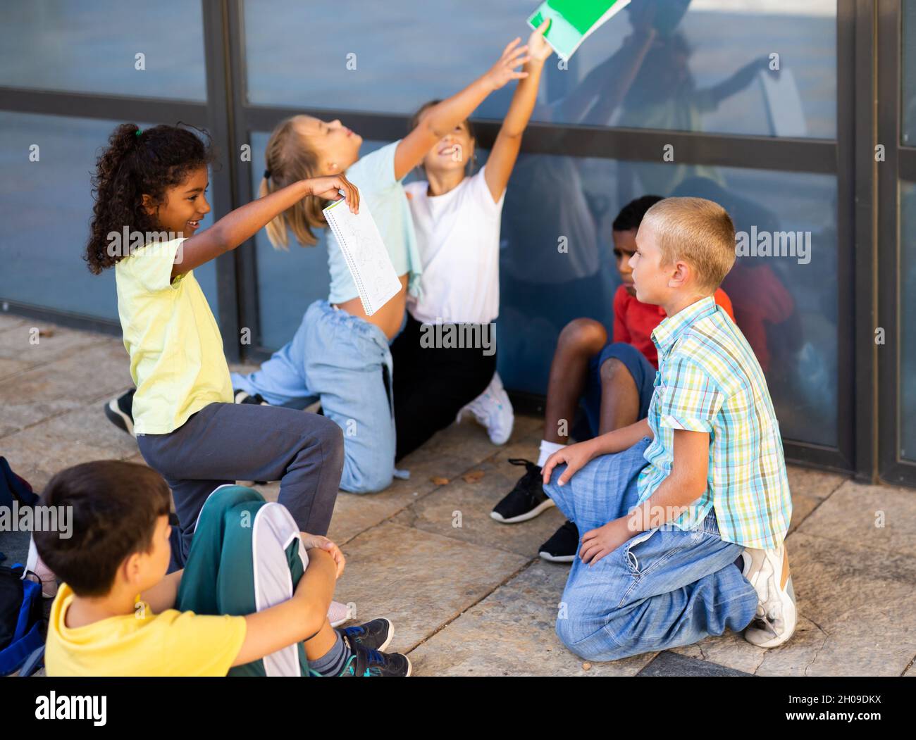 Tweenagers students having fun near school building Stock Photo - Alamy
