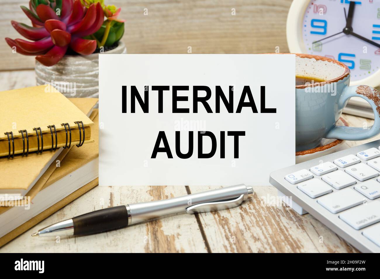 A sign with the inscription INTERNAL AUDIT on the table with office ...