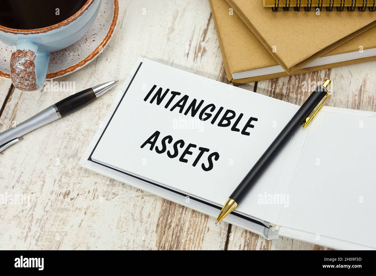 Handwriting text Intangible Assets on the notepad on the background of ...