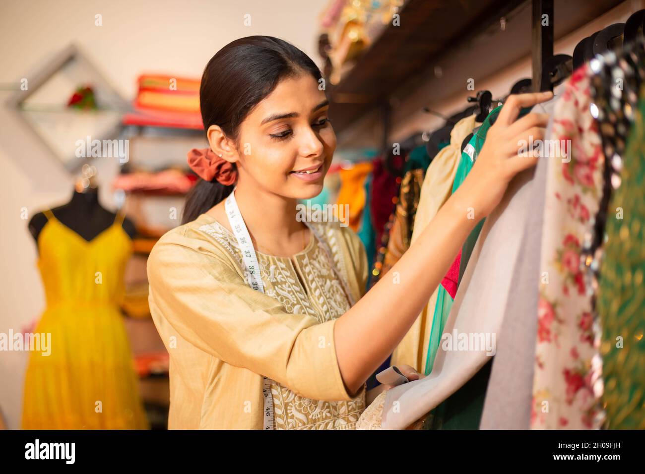 Young happy indian woman,tailor seamstress,fashion designer,checking ...