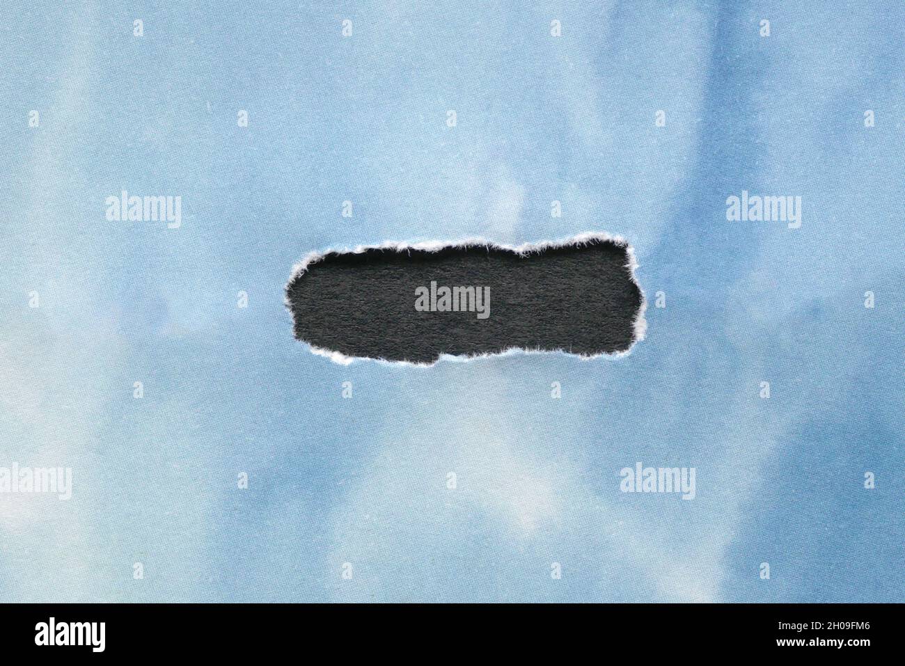 Ripped paper of blue sky on black background. Copy space Stock Photo ...