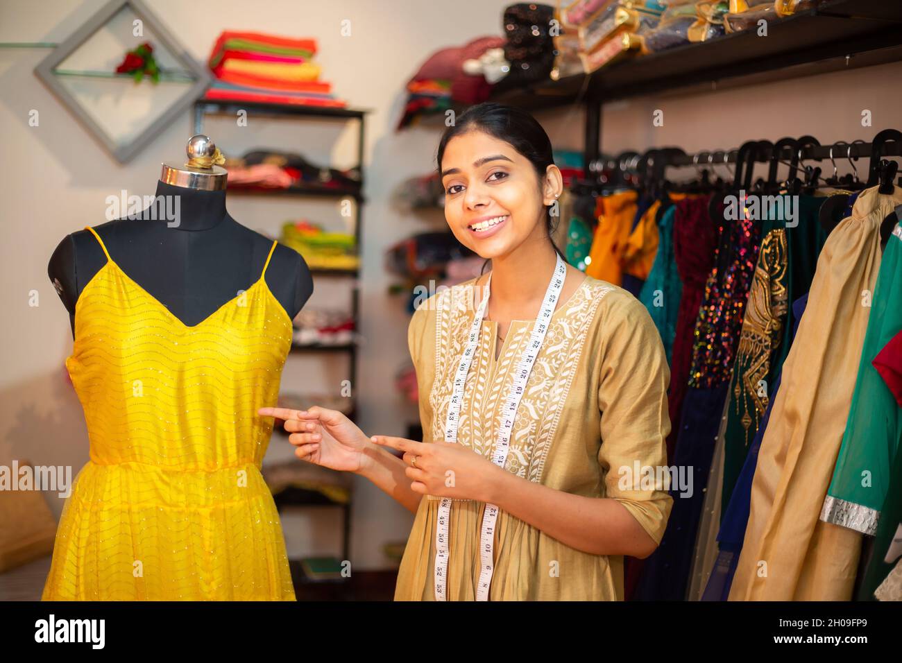 Portrait of Young happy indian woman,tailor or seamstress,smiling ...